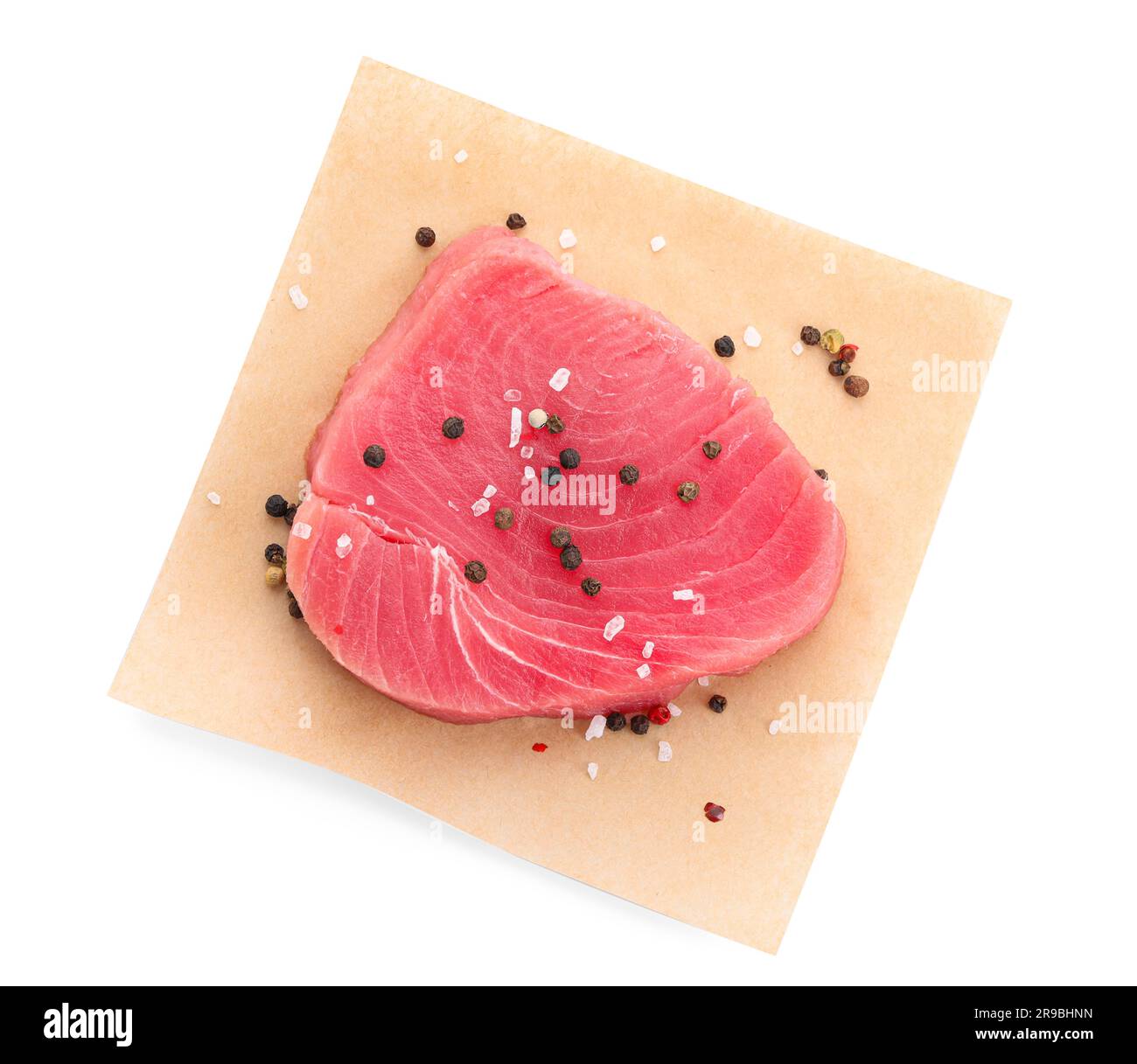 Raw tuna fillet and peppercorns on white background, top view Stock ...
