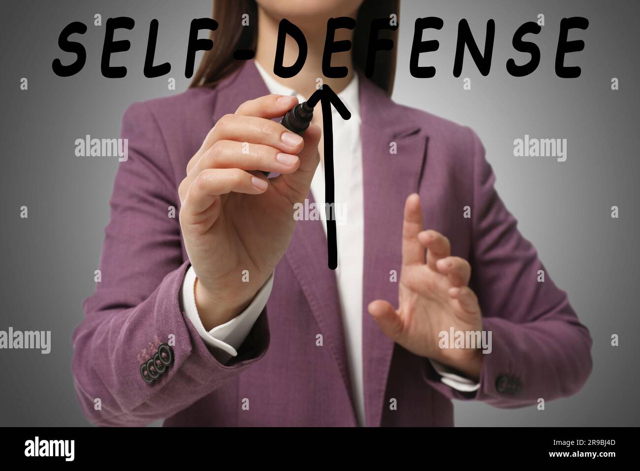 Self Defense Woman Drawing Arrow With Marker On Glass Board Against 5840