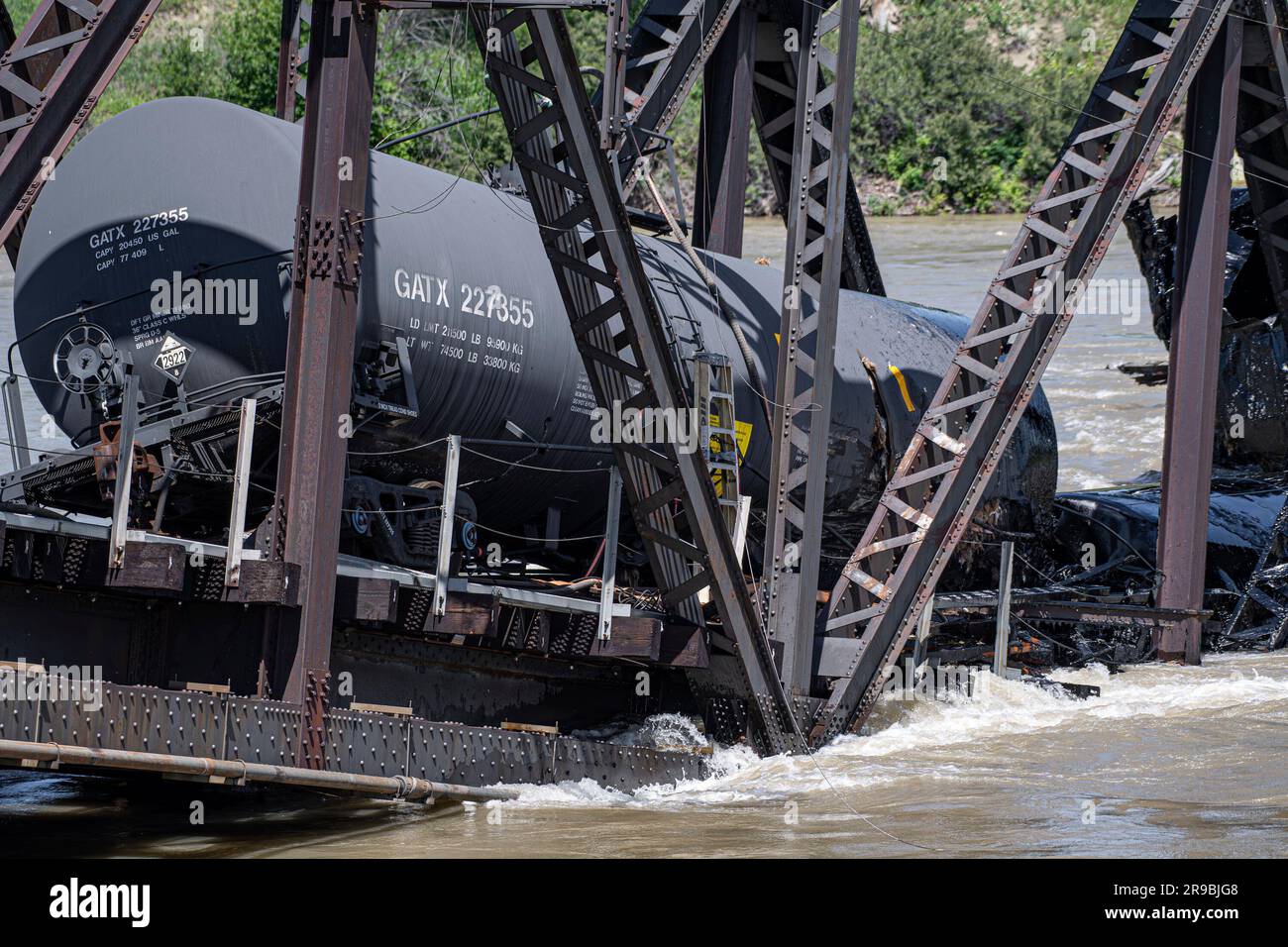 Rail cars remain in the river after a railroad bridge collapse the day ...