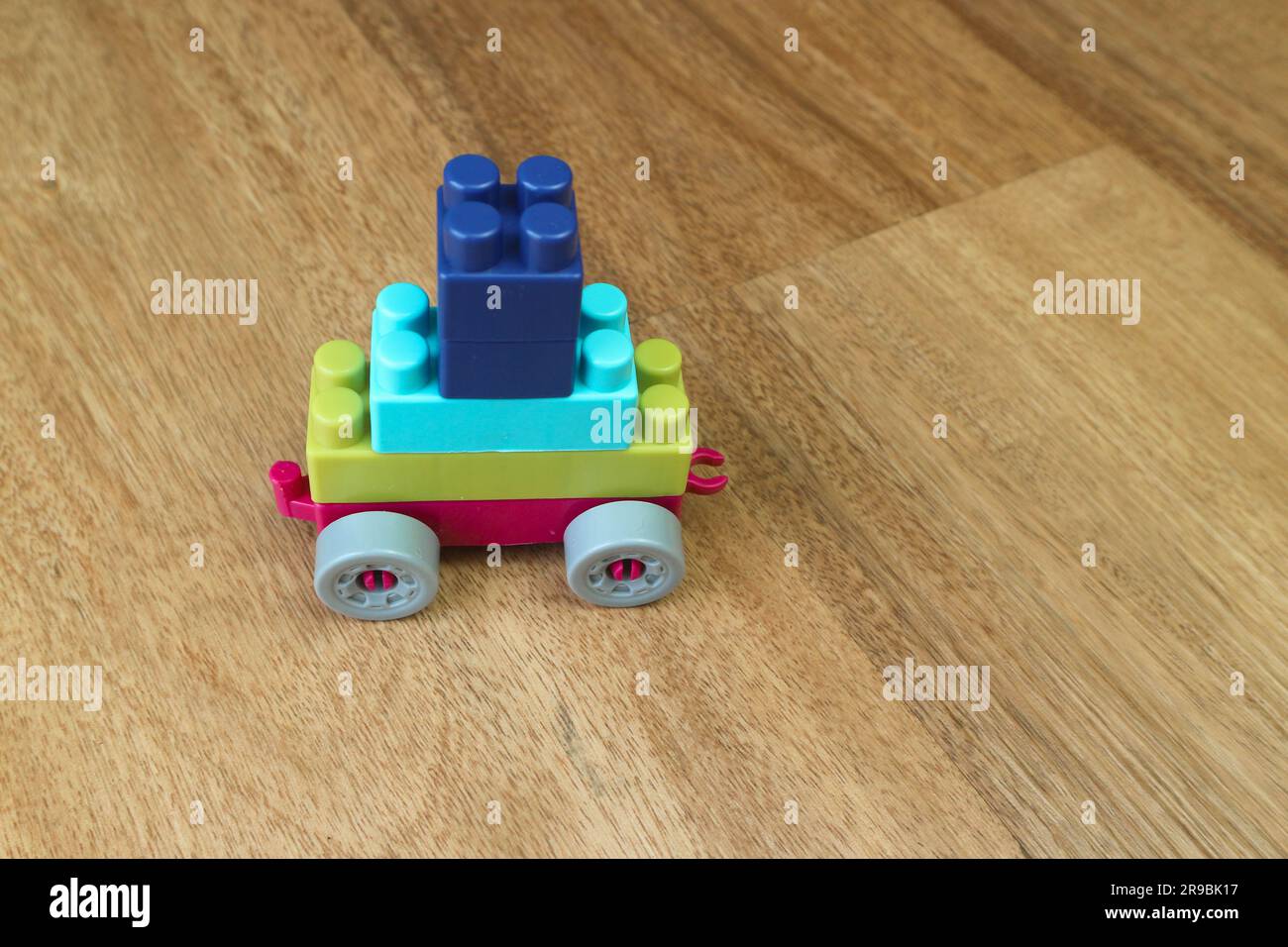 Plastic building blocks form vehicle on wooden background Stock Photo ...