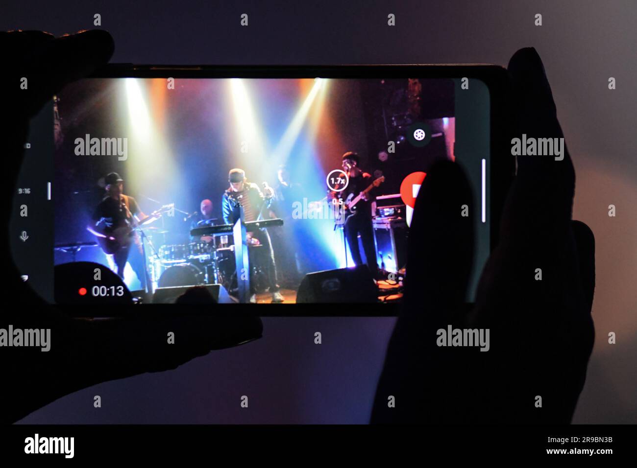 Recording of a concert with the cellphone from the audience Stock Photo ...
