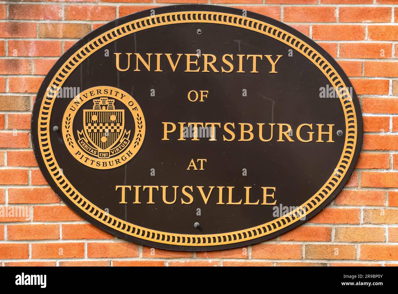 The University of Pittsburgh at Titusville campus sign on a brick wall ...