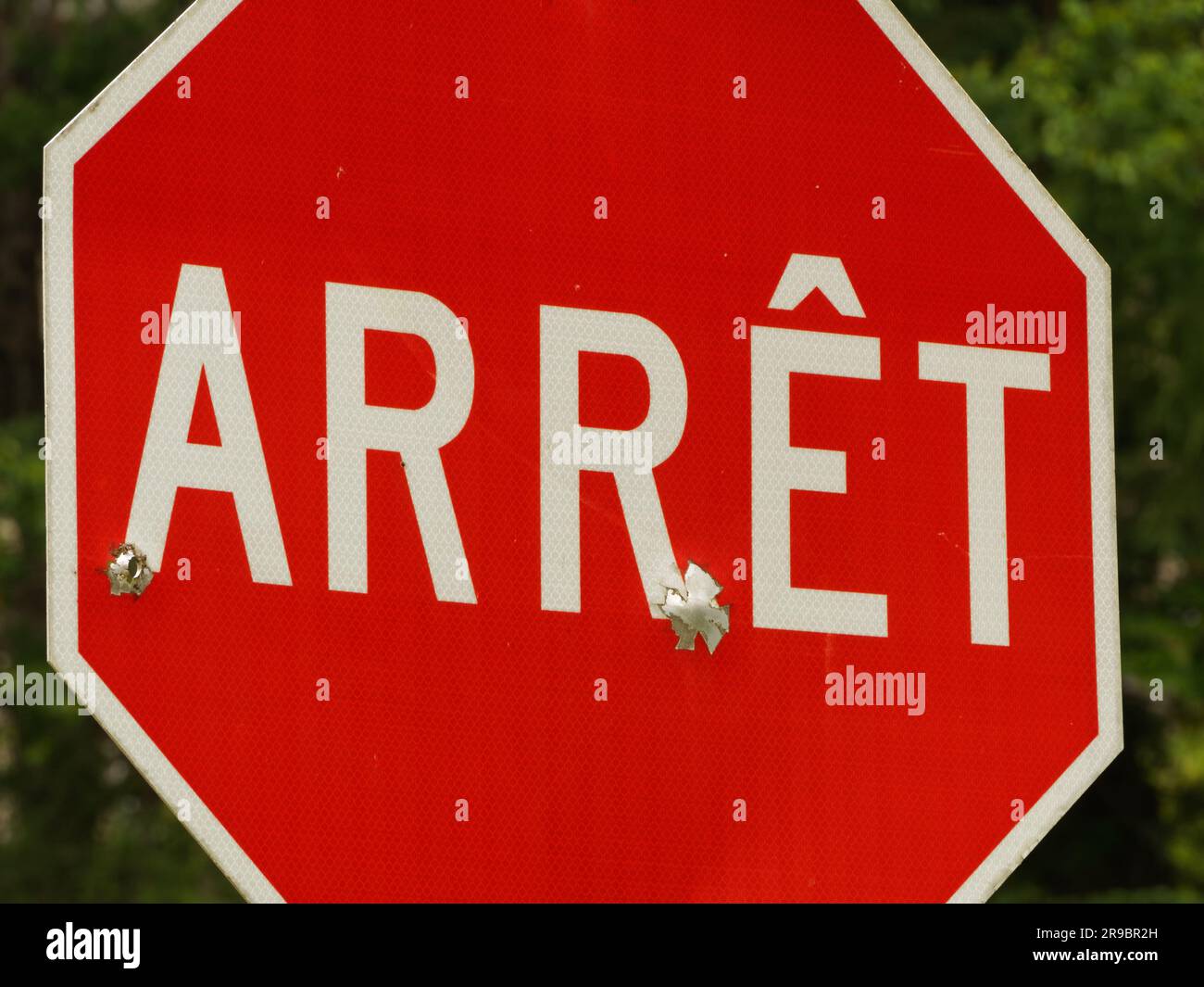 French stop sign in Quebec with a bullet hole. Canada Stock Photo - Alamy
