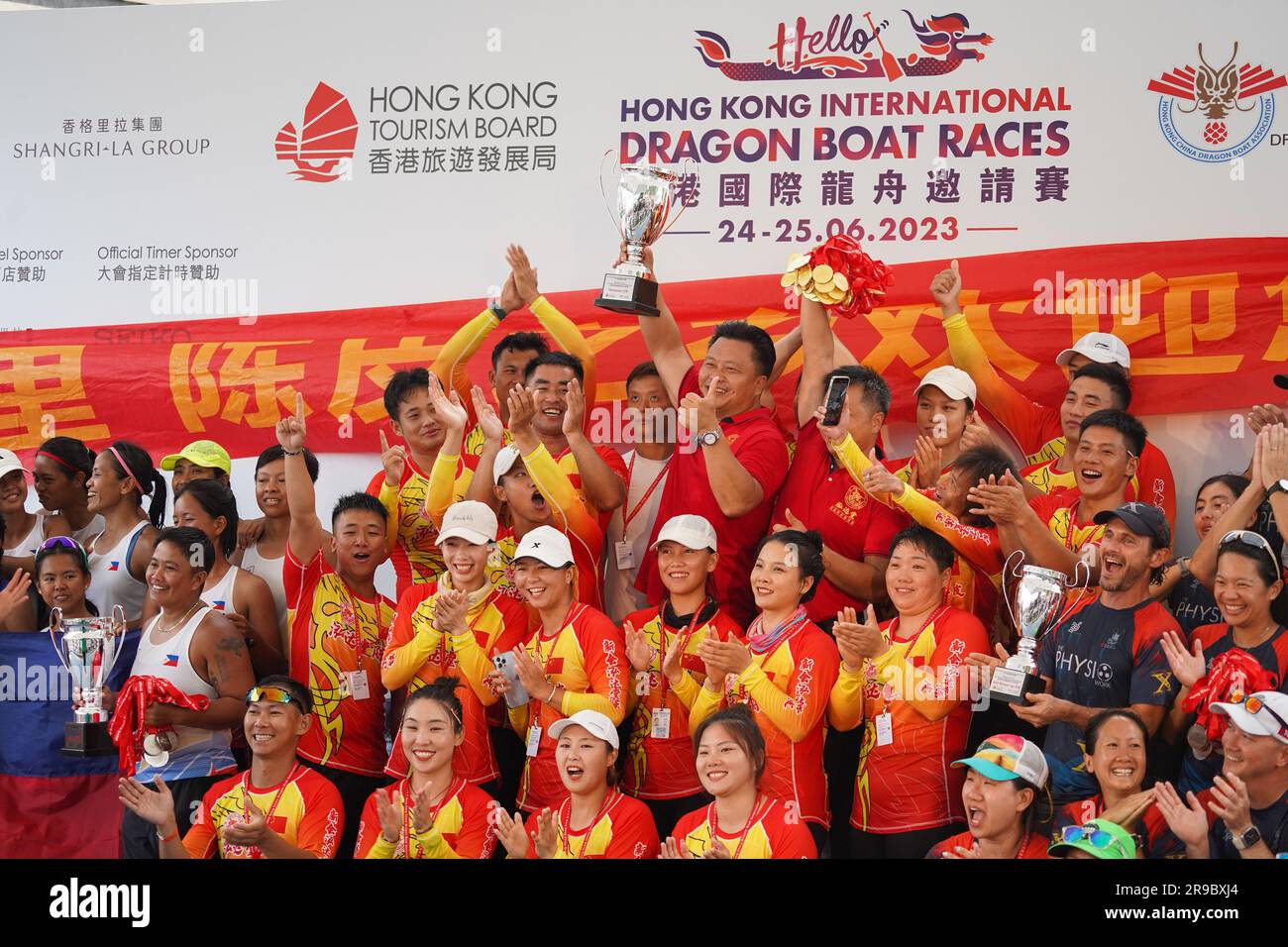 The winning teams of the dragon boat races pose on the podium. The Hong ...