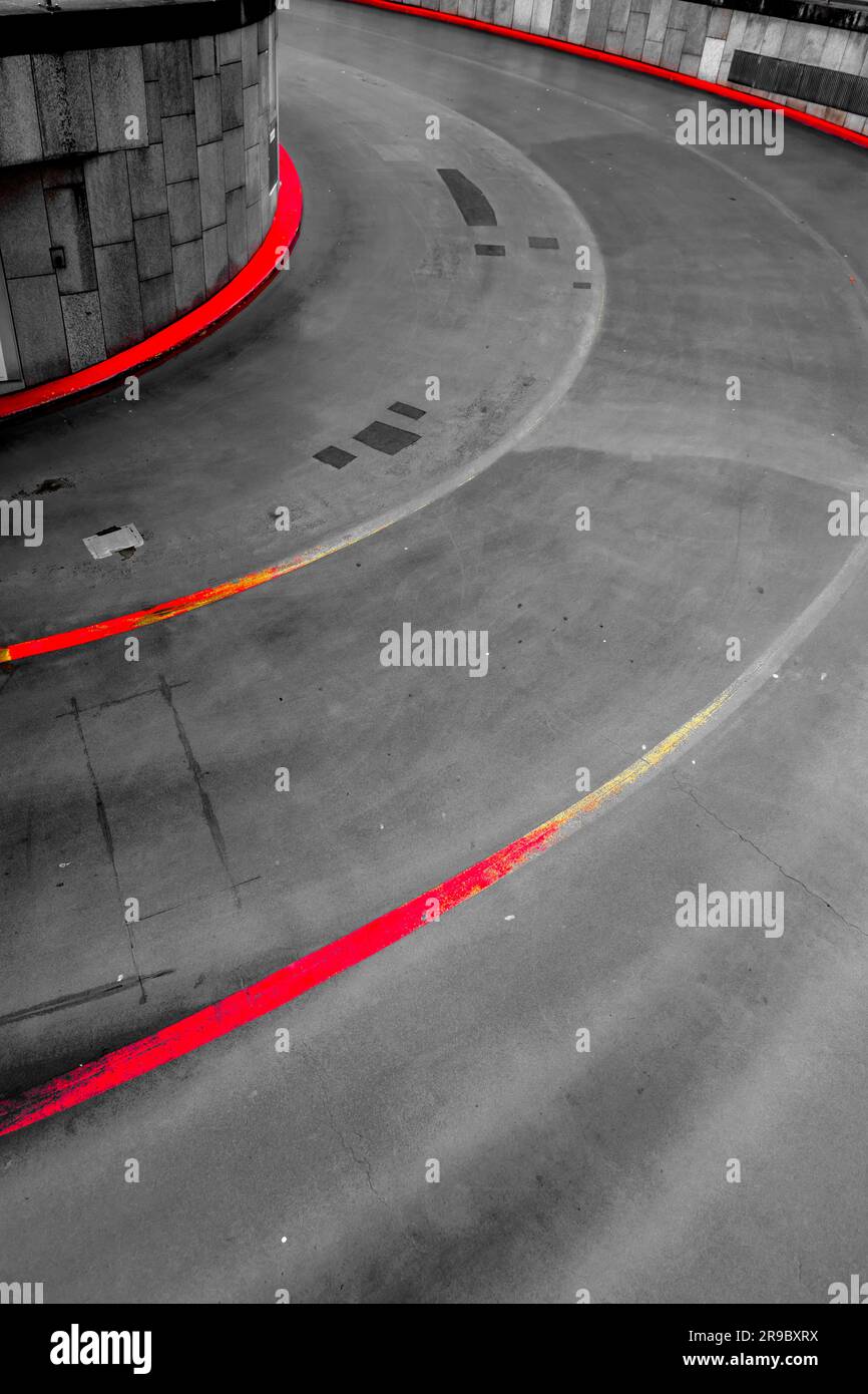 Curved asphalt parking lot entrance with red stripes Stock Photo - Alamy