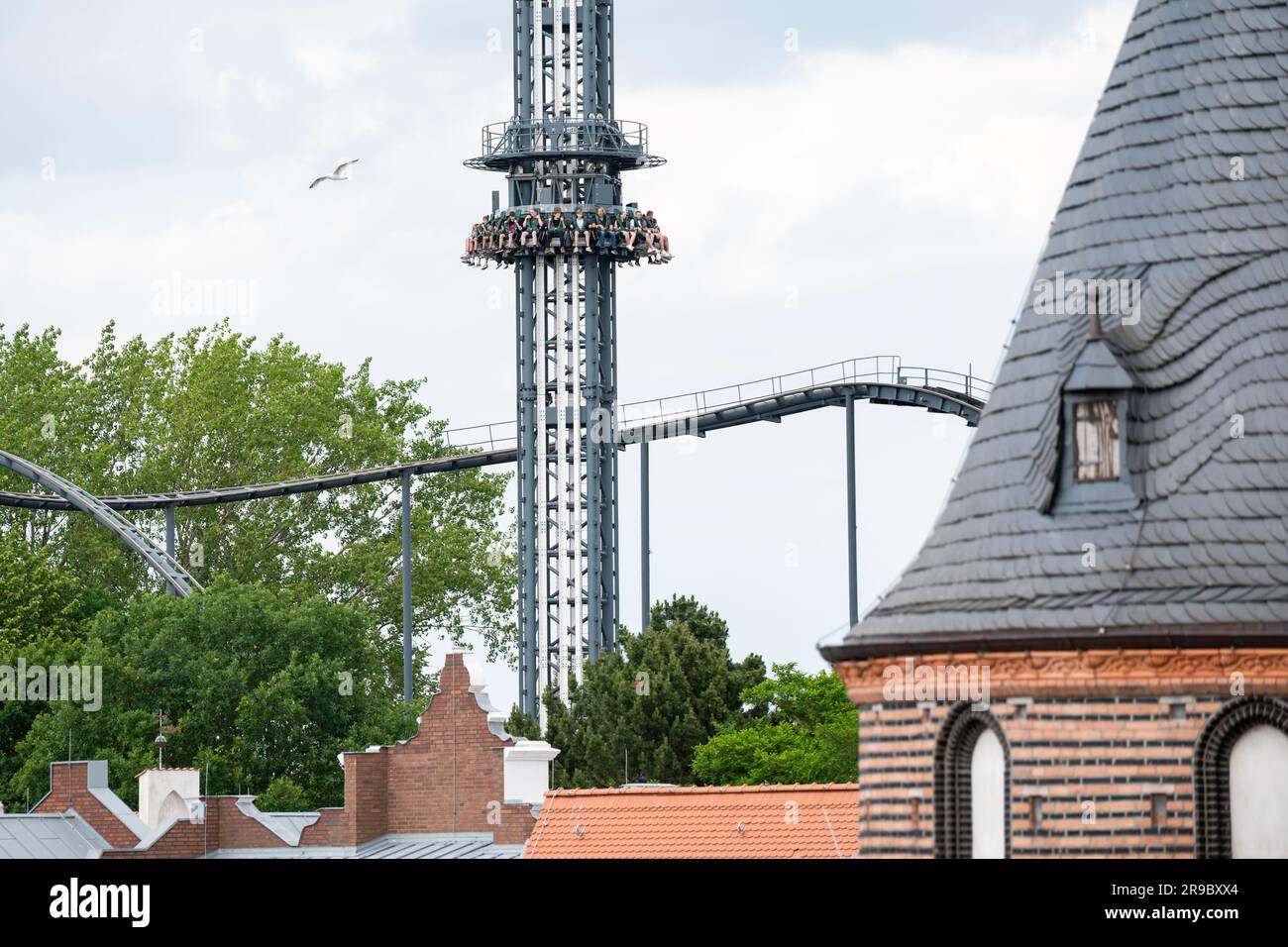 Sierksdorf, Germany. 24th June, 2023. Visitors ride a ride above trees ...