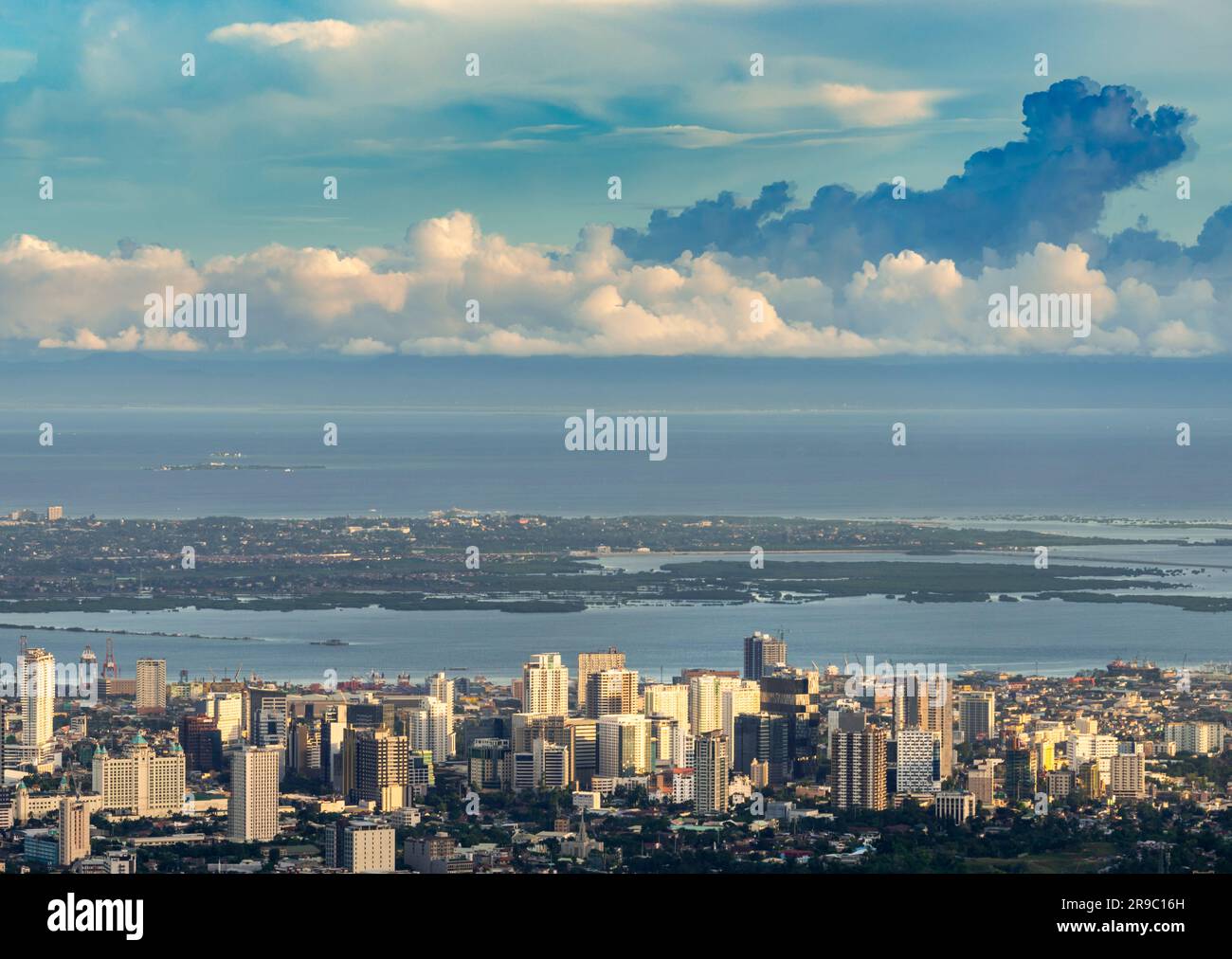 Light from the setting sun bathes the high-rise buildings in the ...