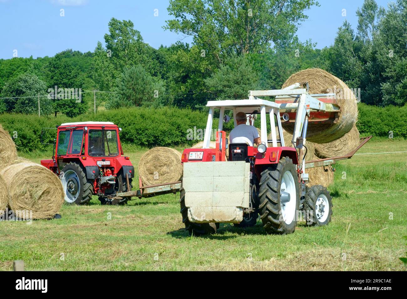 steyr 650 tractor being used to stack round hay bales unloaded from ...