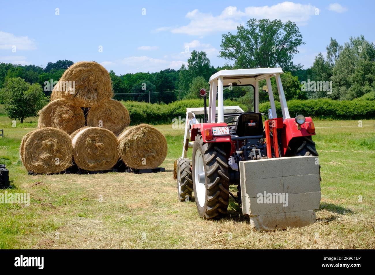 steyr 650 tractor being used to stack round hay bales after harvesting ...