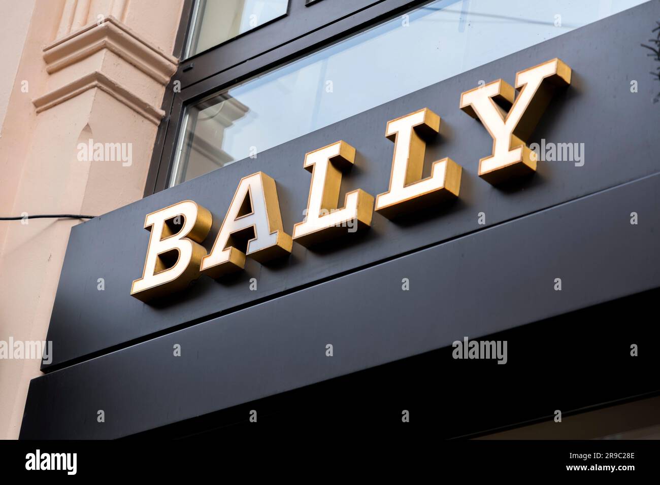 Munich, Germany - December 25, 2021: Bally brand sign and logo at the entrance of luxury stores ...