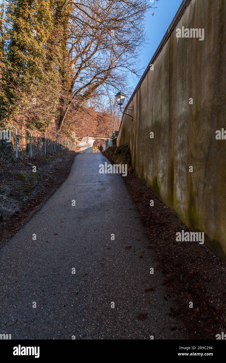 Walking path and trees and an archway in a park in Salzburg, Austria ...