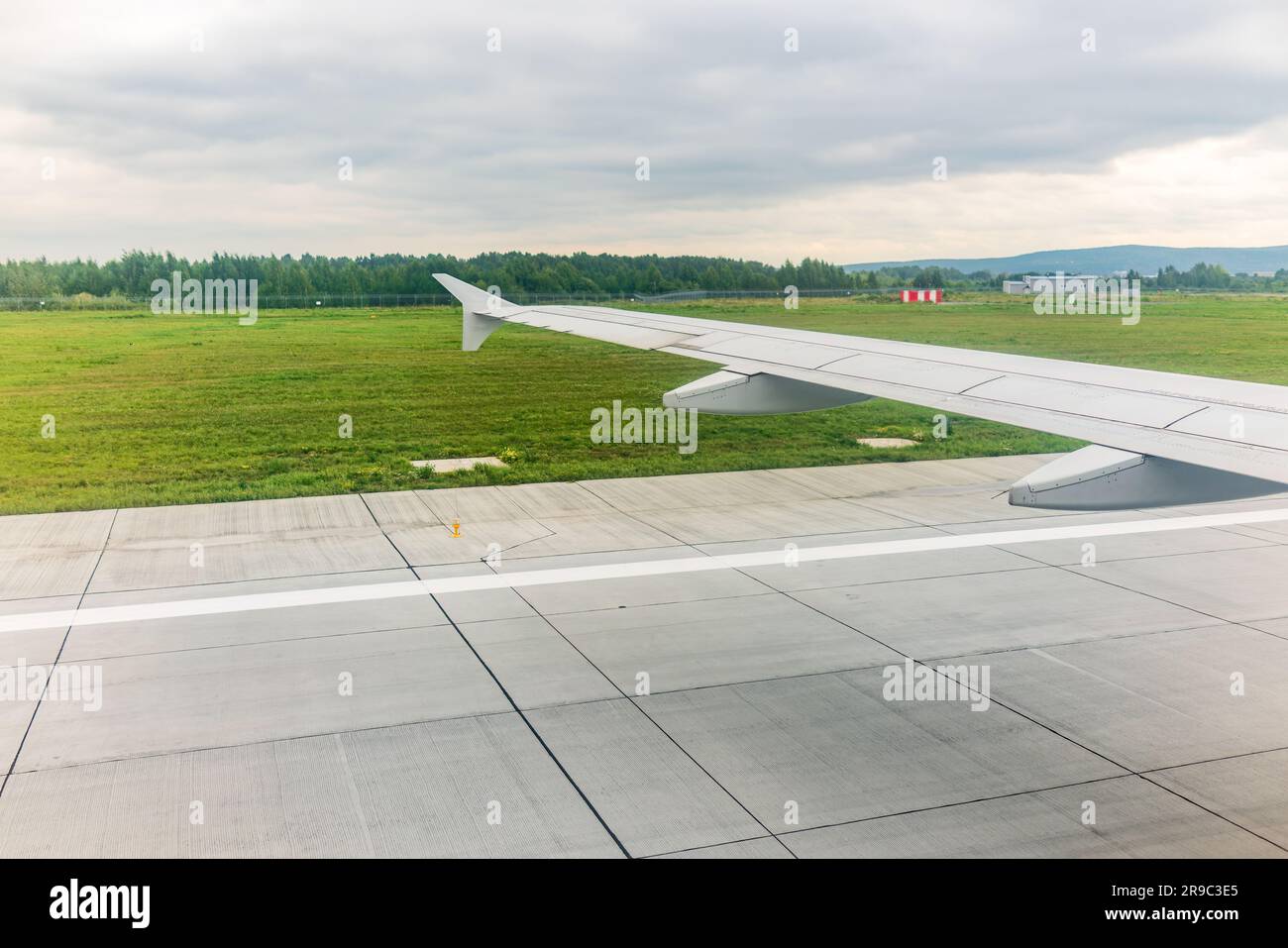View of airplane wing, blue skies and green land during landing ...