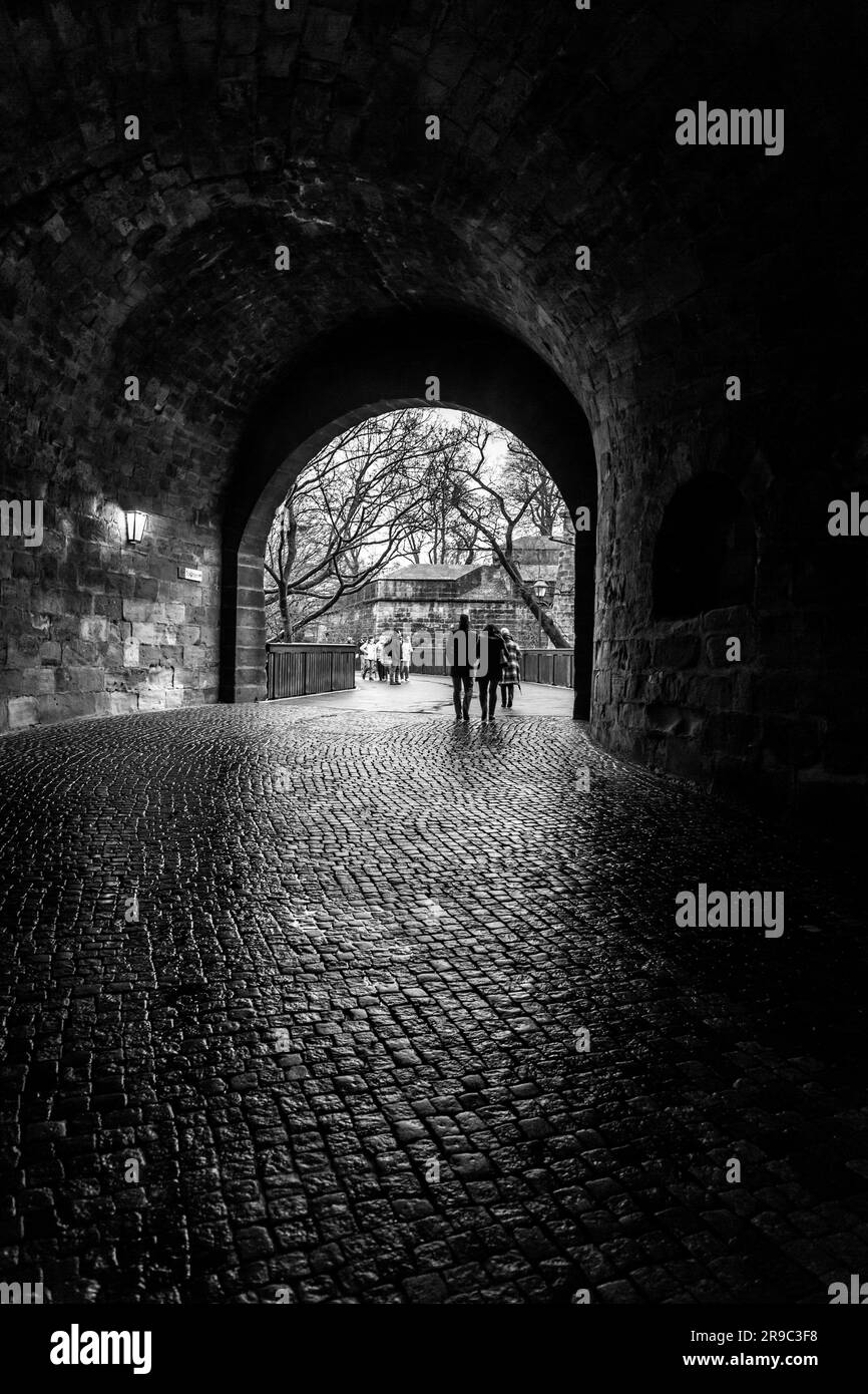 Stone arch gate way through the Nuremberg Castle in the old town of ...