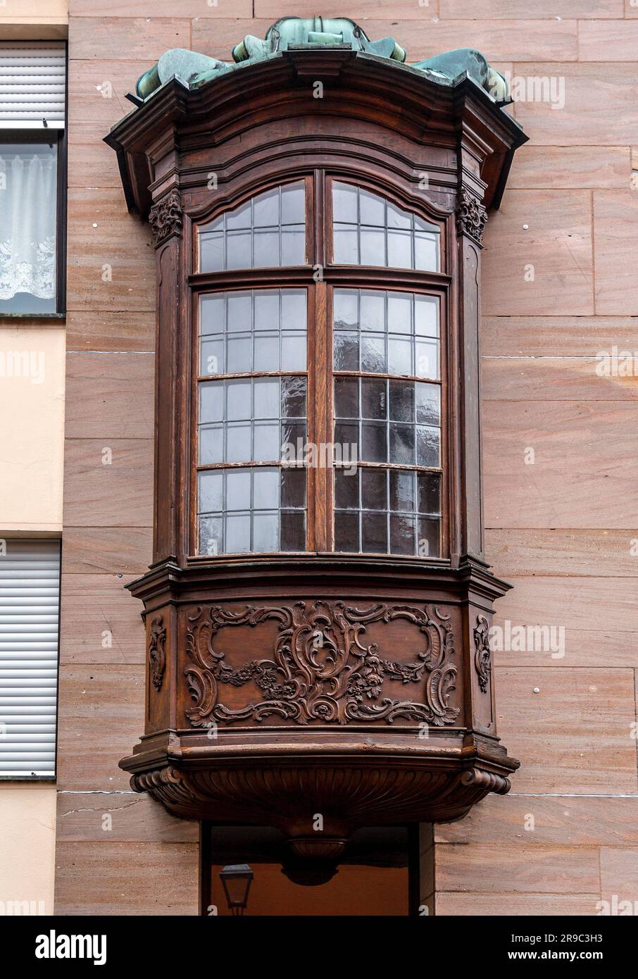 Oriel window with wooden carved decorations in the old town of Nuremberg, Germany Stock Photo ...
