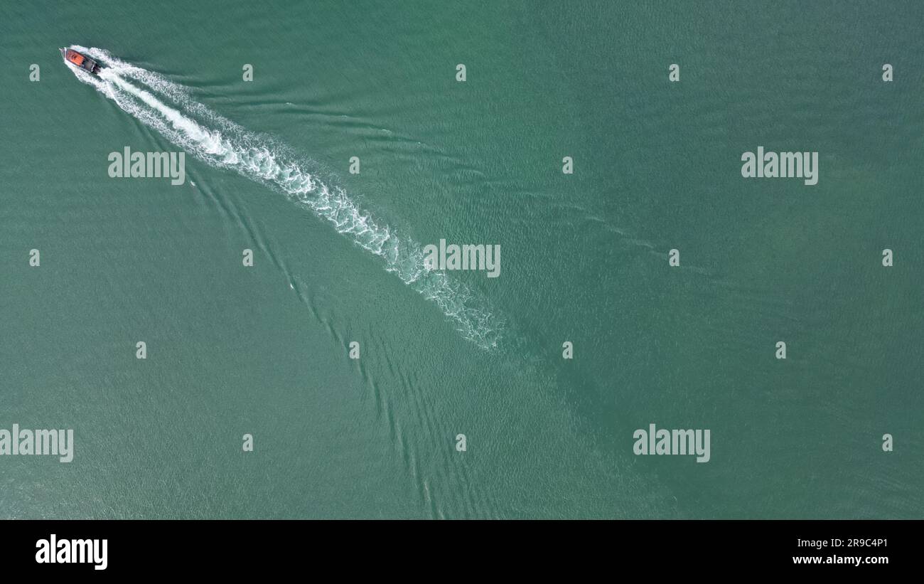 An aerial view of a sailboat drifting across the vast ocean Stock Photo ...