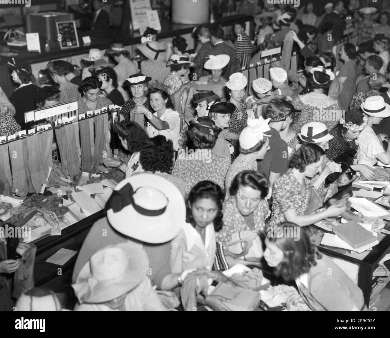 New York, New York: c. 1941 Crowds of women are buying silk stockings ...