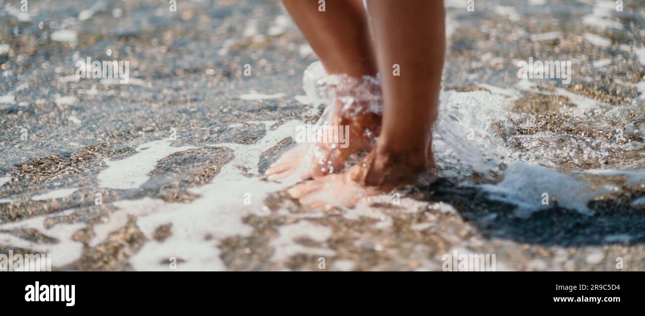 A woman walks along the beach, legs close-up. Barefoot woman sta Stock ...