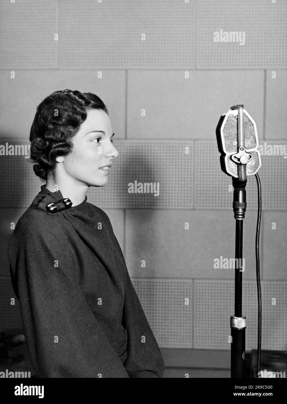 New York, New York: c. 1937 A woman stands in the WOV studio in front ...