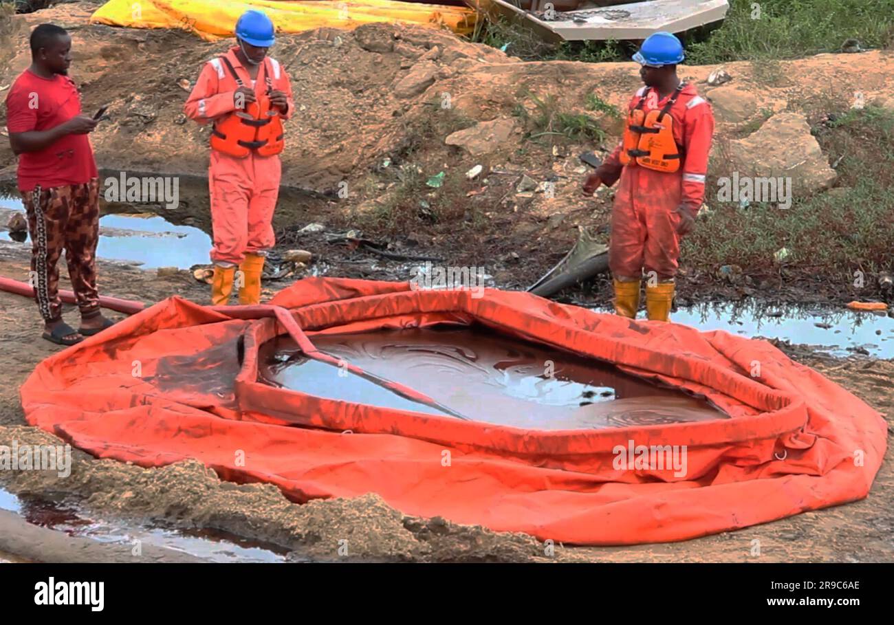 In this grab taken from video, workers stand by a container to collect oil spill waste, in ...