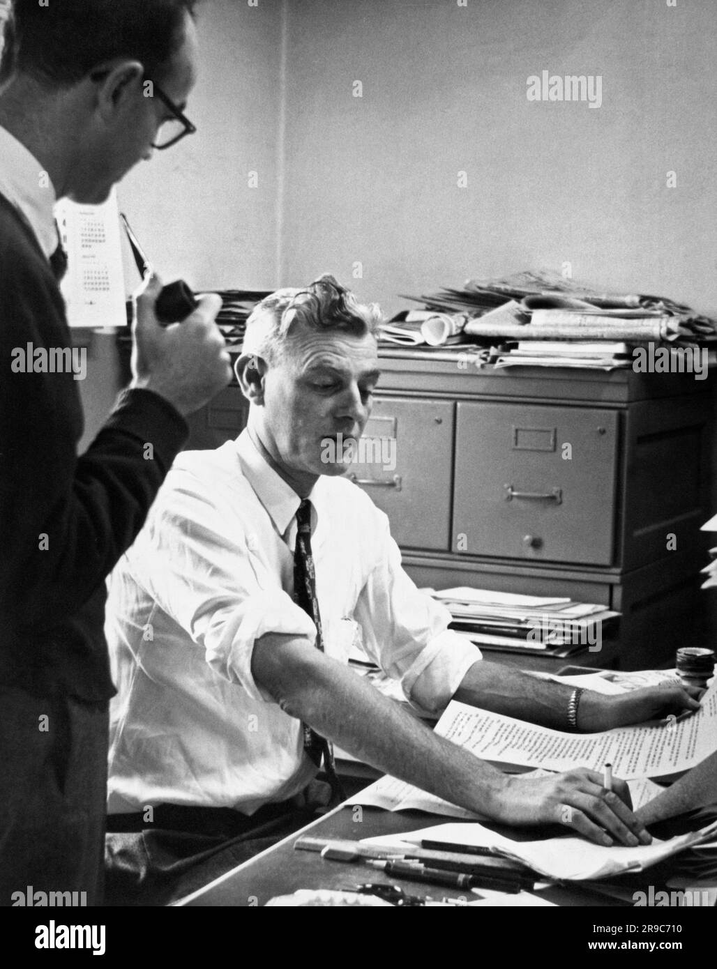 California: c. 1938 The newspaper's managing editor consulting with ... California: c. 1938 The newspaper's managing editor consulting with ...