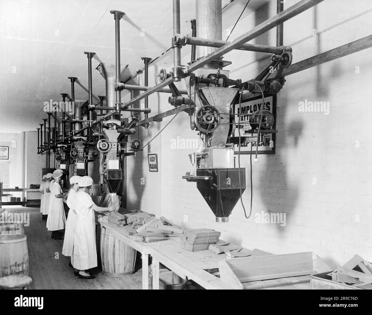 United States: c. 1913 Women employees using Scott filling machines in ...