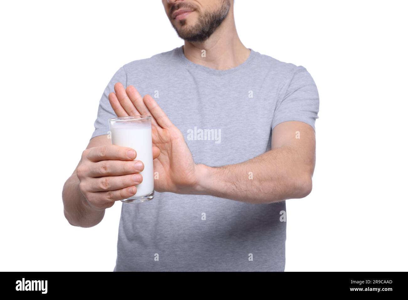 Man with glass of milk suffering from lactose intolerance on white ...