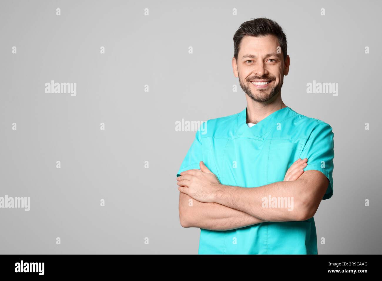 Doctor or medical assistant (male nurse) in uniform on light grey ...