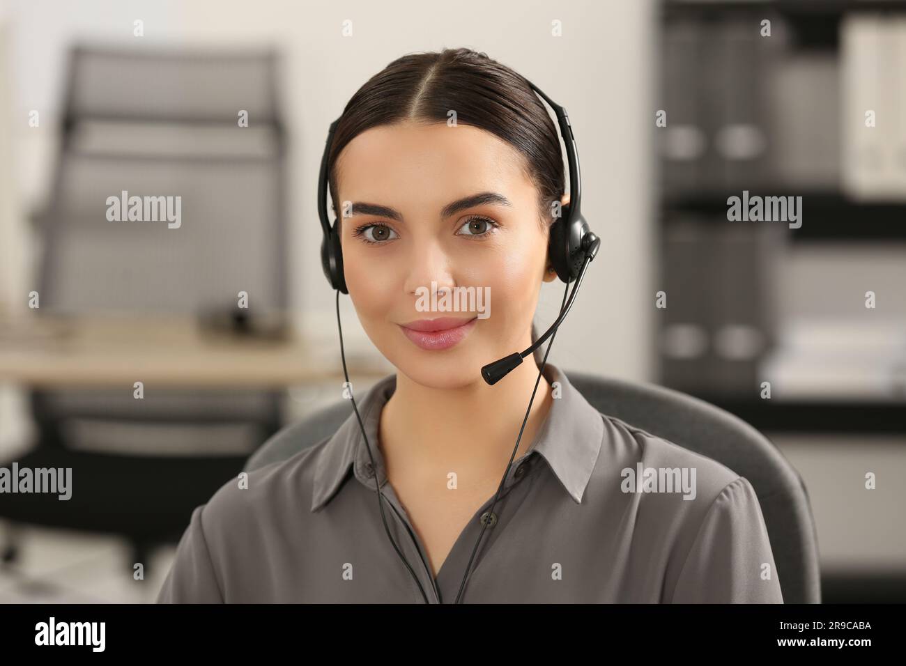 Hotline operator with headset working in office Stock Photo - Alamy