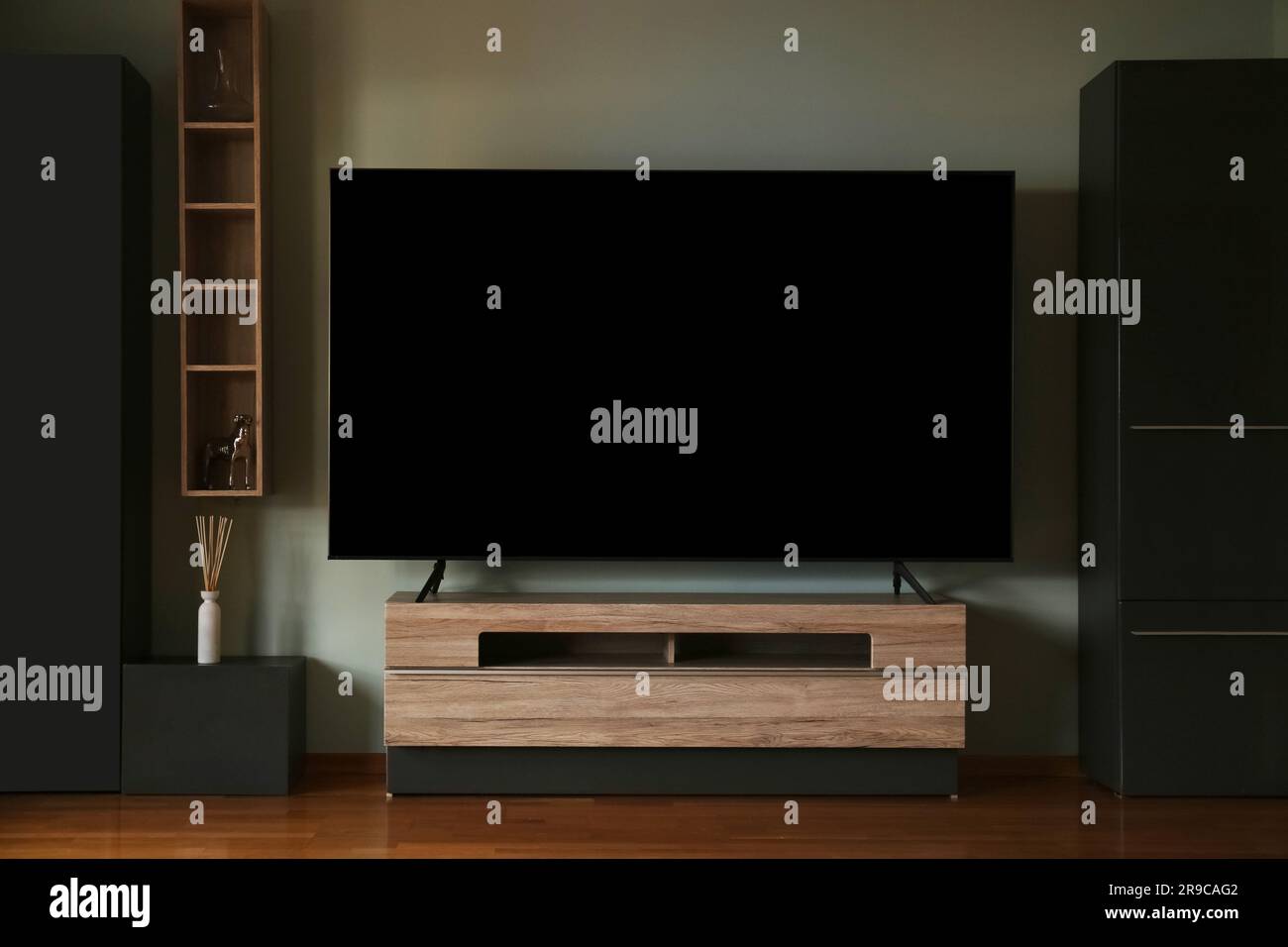 Modern TV set on table in room. Interior design Stock Photo - Alamy