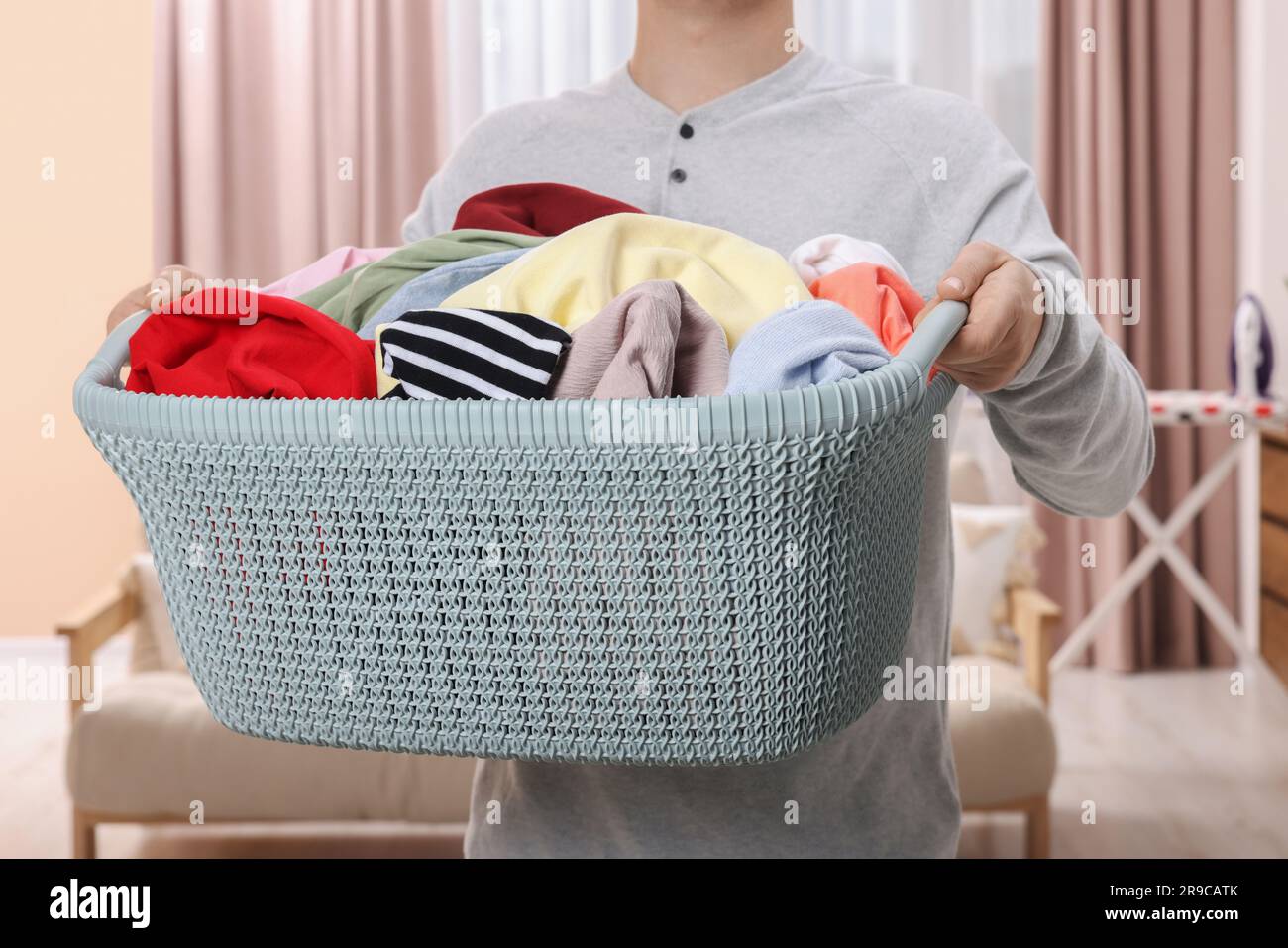 Man holding laundry full clothes hi-res stock photography and images ...