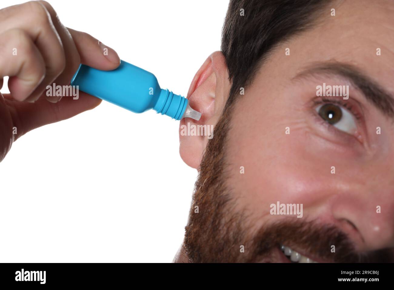 Man using ear drops on white background, closeup Stock Photo - Alamy
