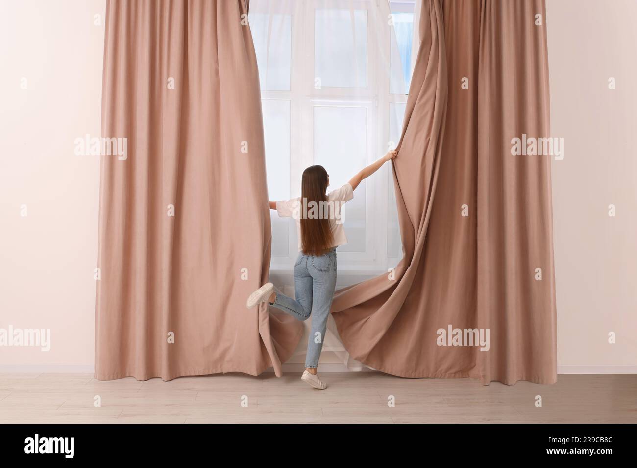 Woman opening stylish curtains hi-res stock photography and images - Alamy