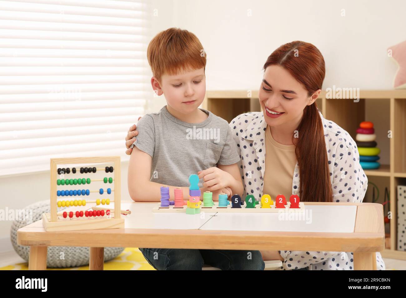 Happy mother and son playing with Educational game Fishing for Numbers ...