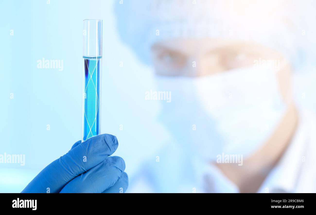 Genetics research. Scientist holding test tube with liquid and ...