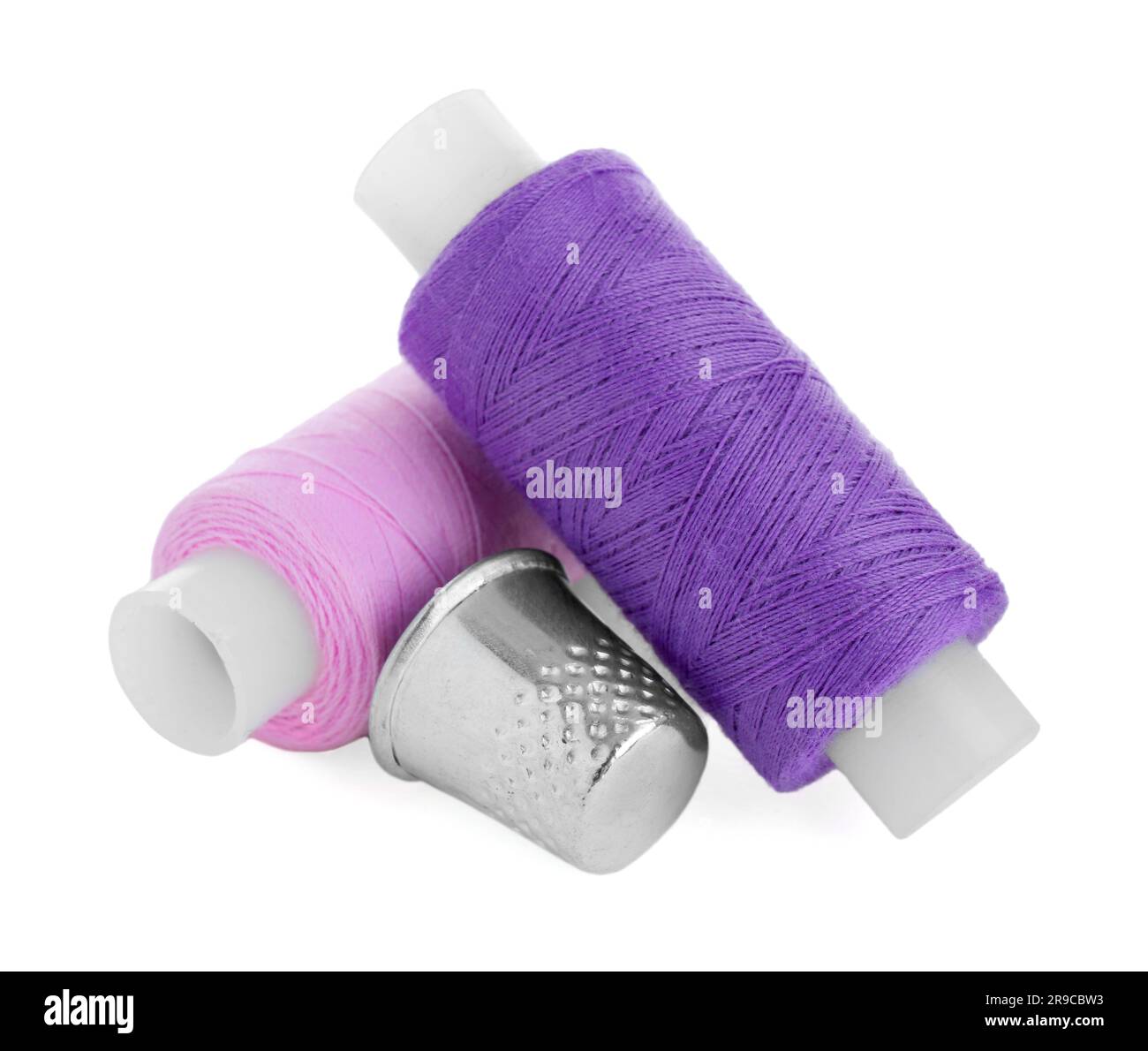 Thimble and spools of sewing threads isolated on white Stock Photo - Alamy