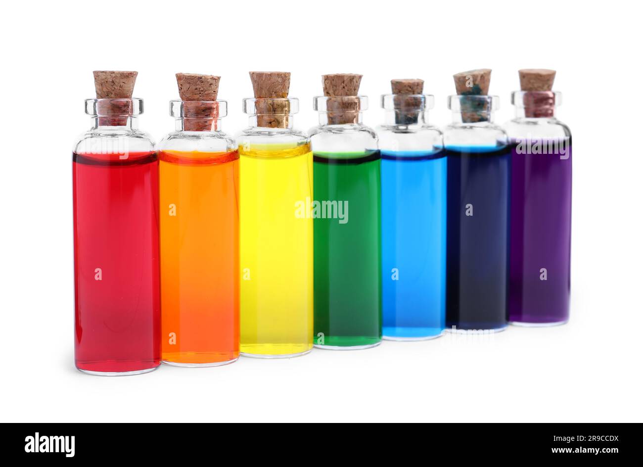 Glass bottles with different food coloring on white background Stock ...