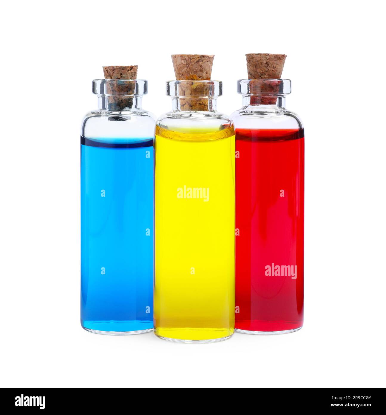 Glass bottles with different food coloring on white background Stock ...
