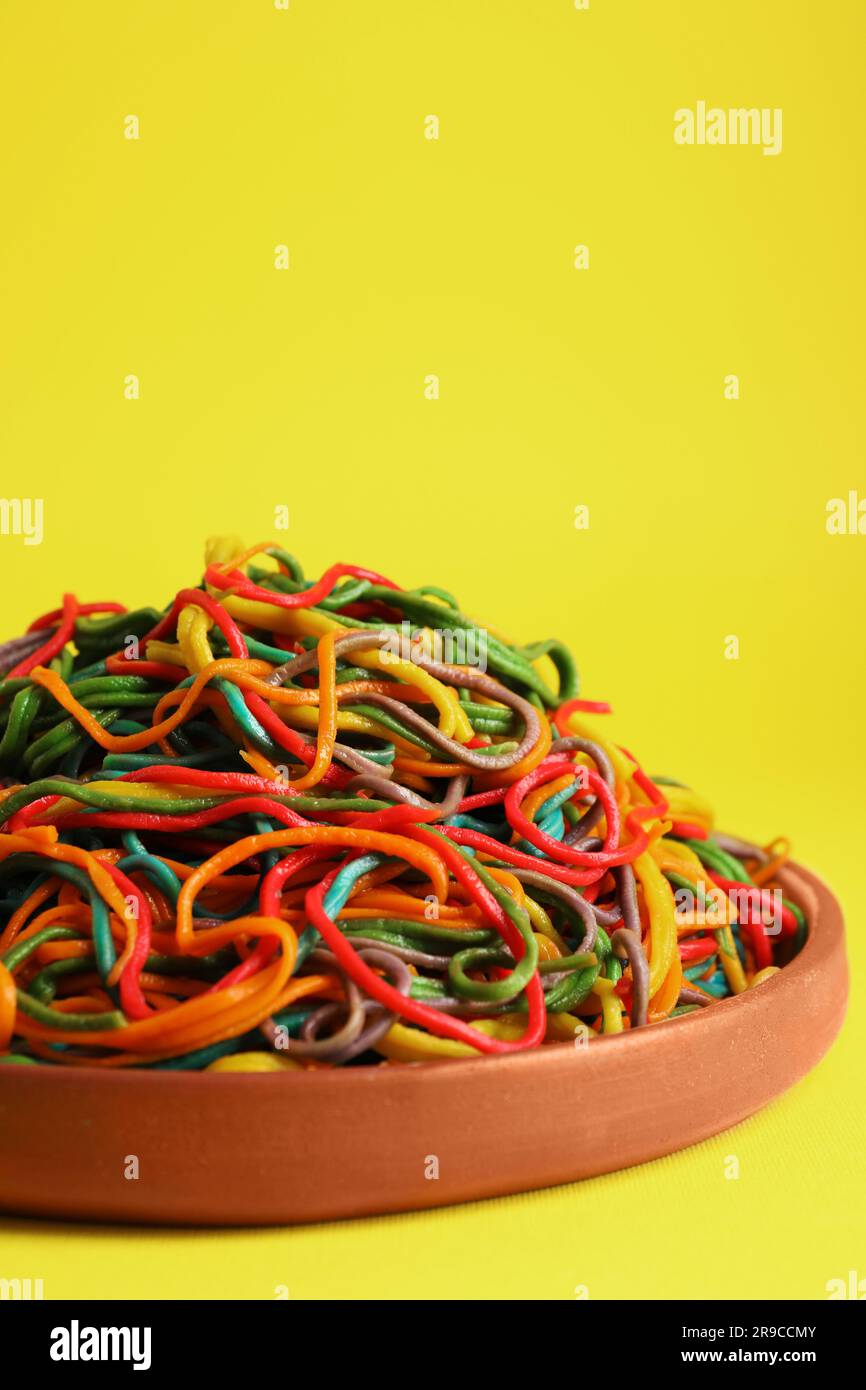 Plate of spaghetti painted with different food colorings on yellow ...