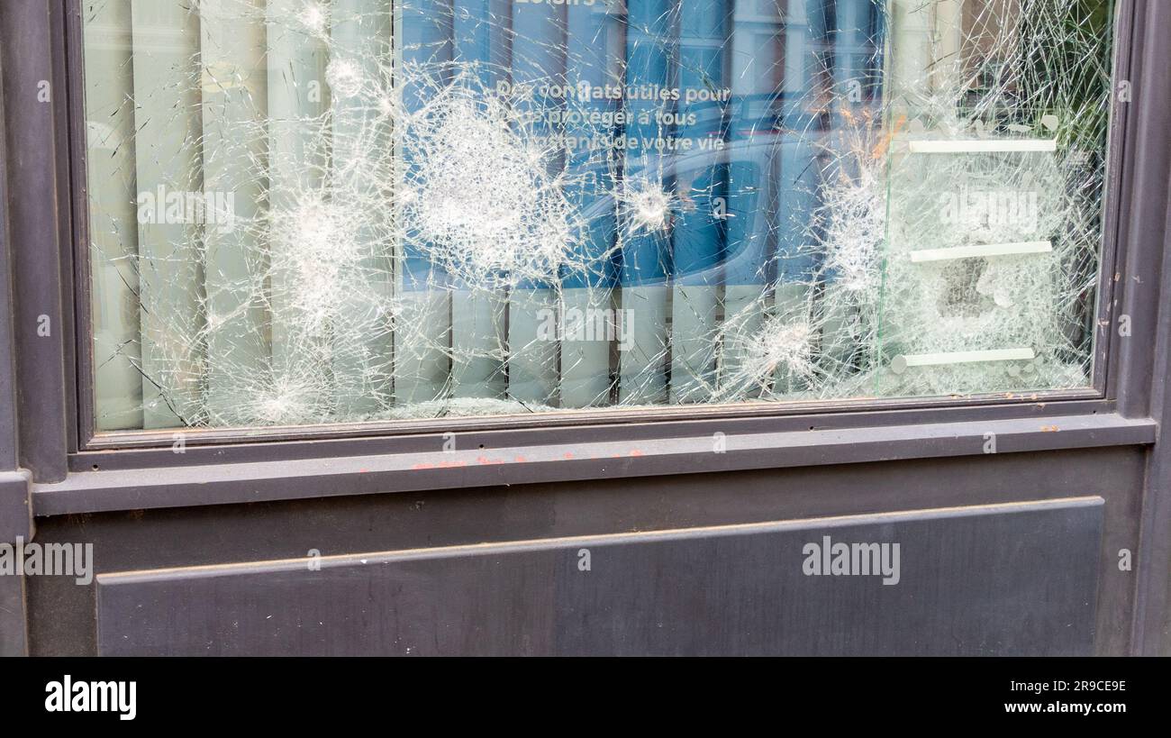 Front door shop smashed window impact of stone and hammer during strike ...