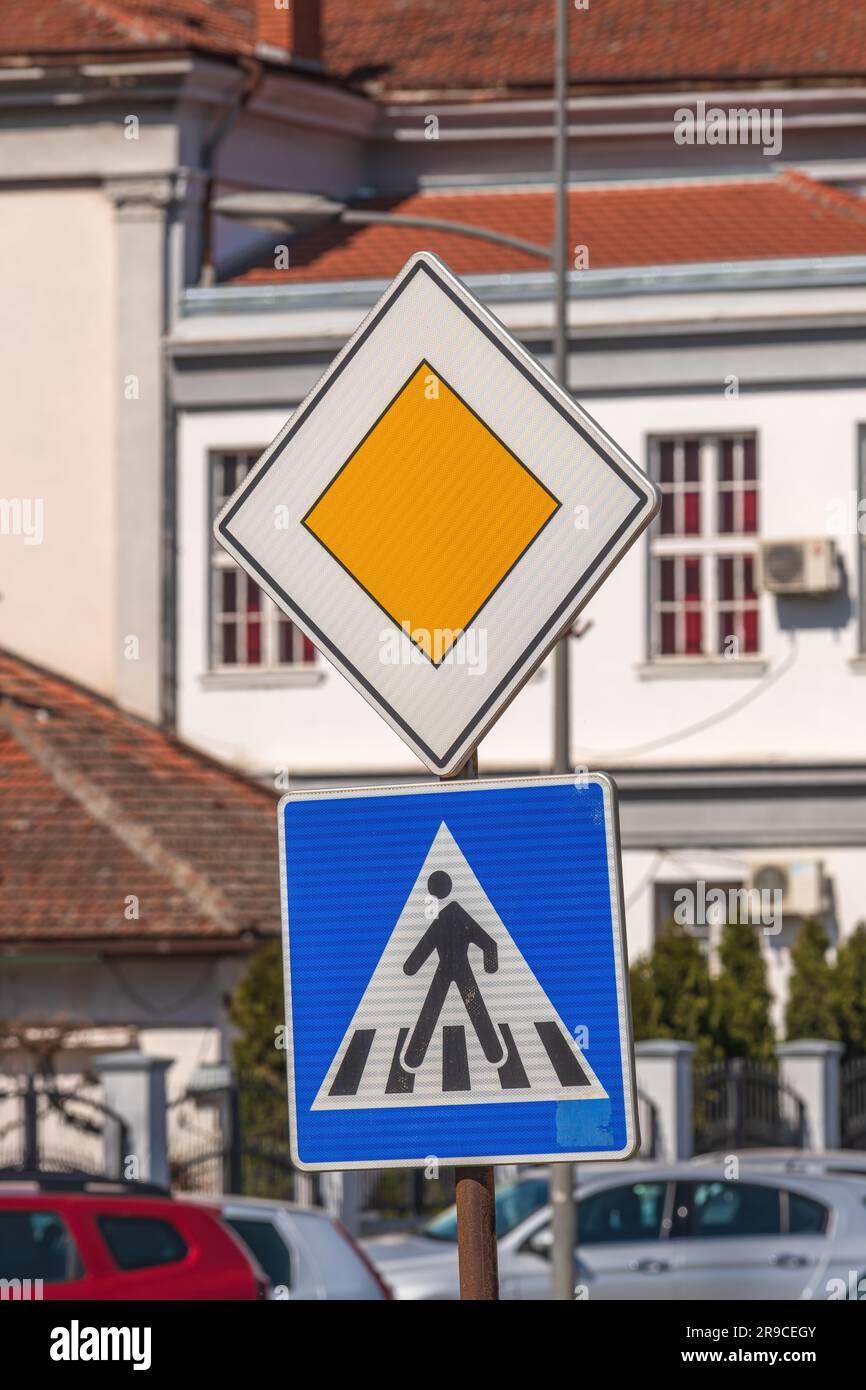 Main road and pedestrian crossing traffic signs on the street, selective focus Stock Photo - Alamy