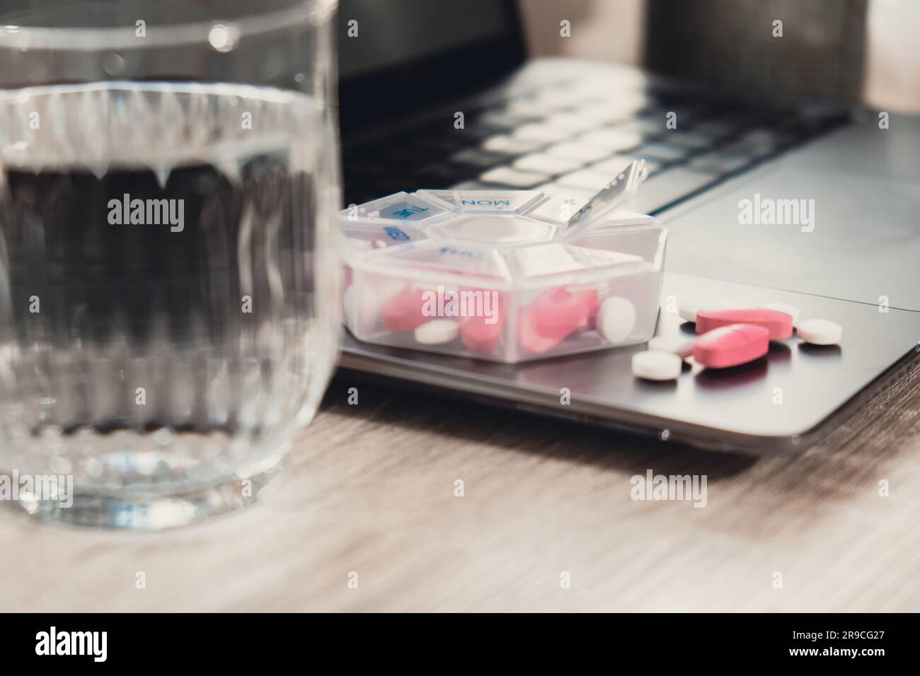 Organizer weekly shots with glass of water on workplace background and ...