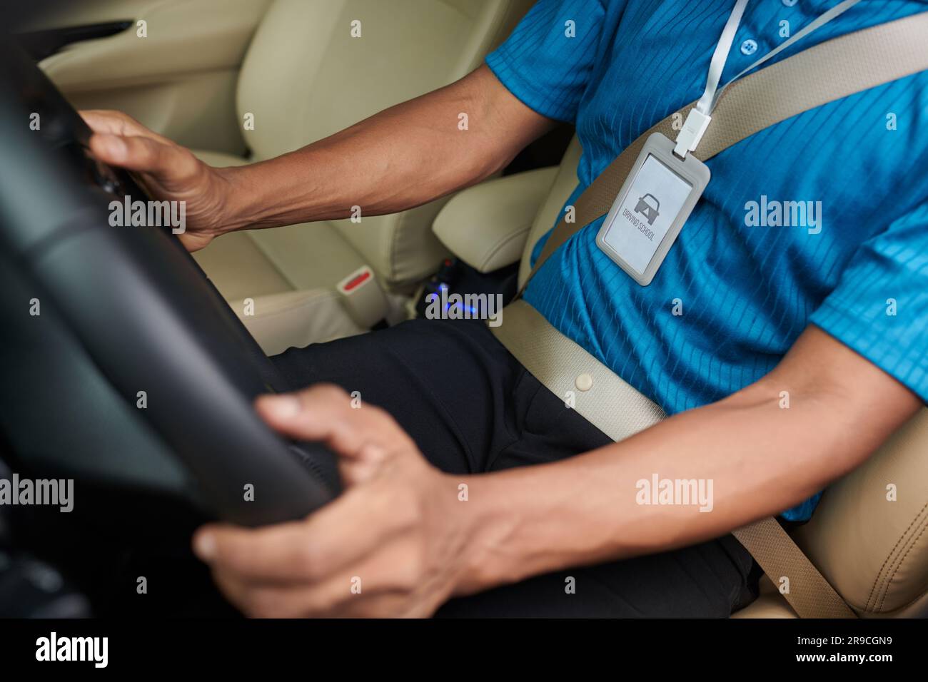 Driving school instructor driving car to work Stock Photo - Alamy