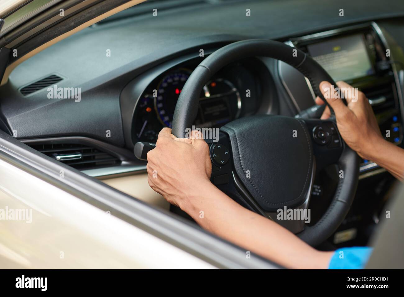 Closeup image of driver turning steering wheel Stock Photo - Alamy