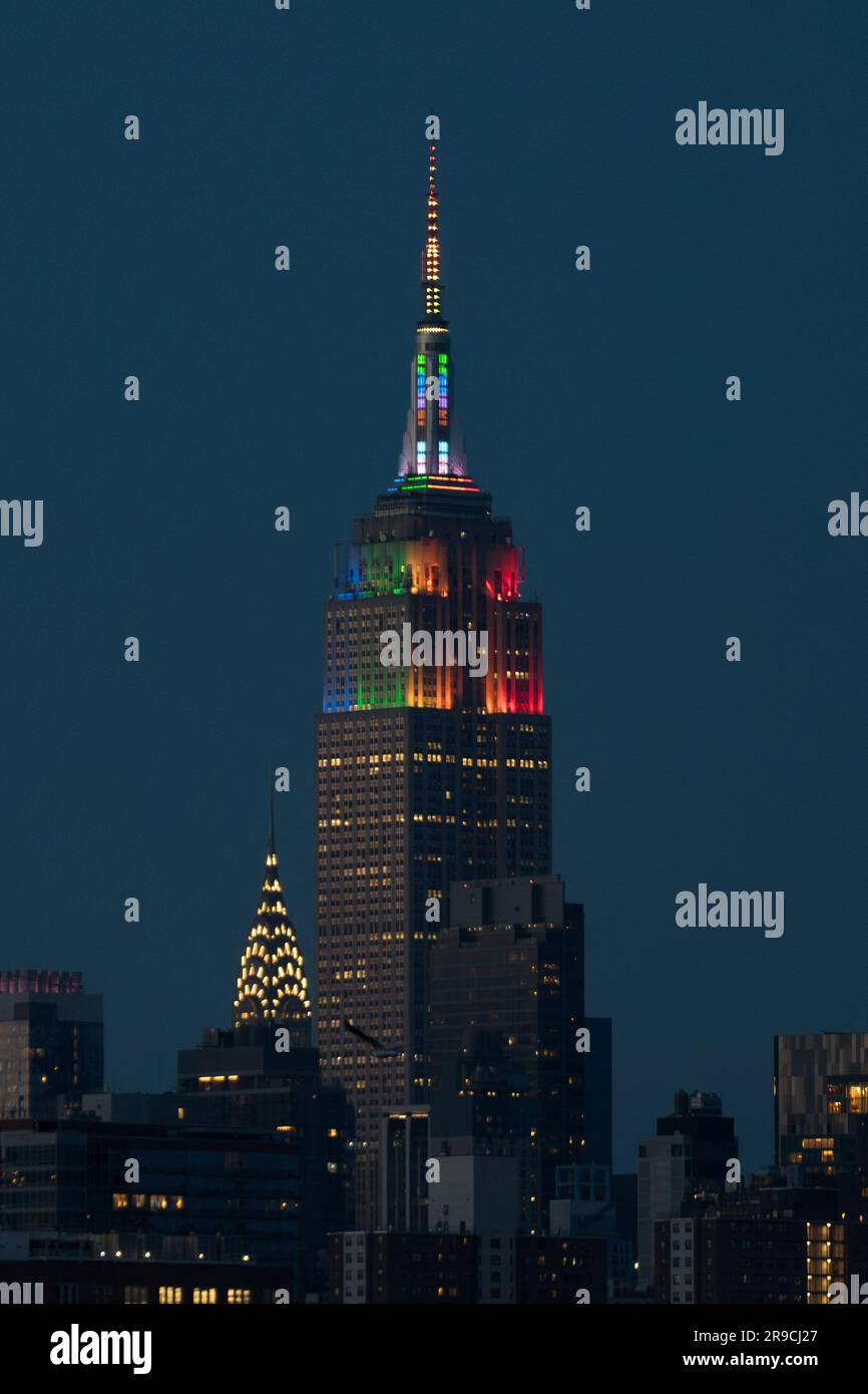 View of the Empire State Building illuminated with rainbow colors in ...