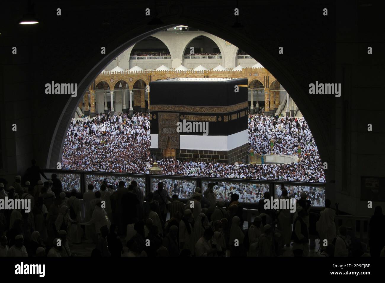 Muslim pilgrims circumambulate around the Kaaba, the cubic building at ...