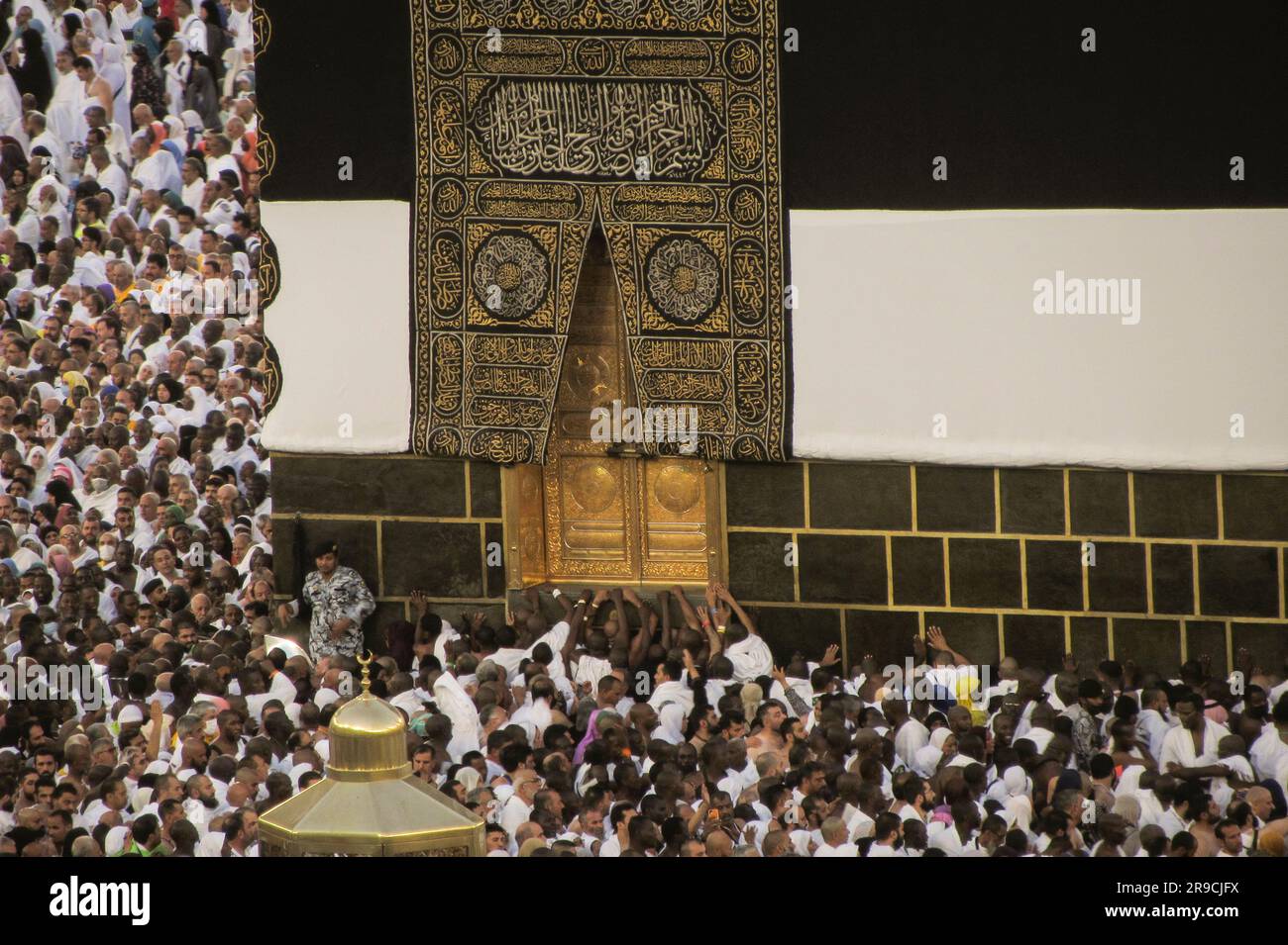 Muslim pilgrims circumambulate around the Kaaba, the cubic building at ...