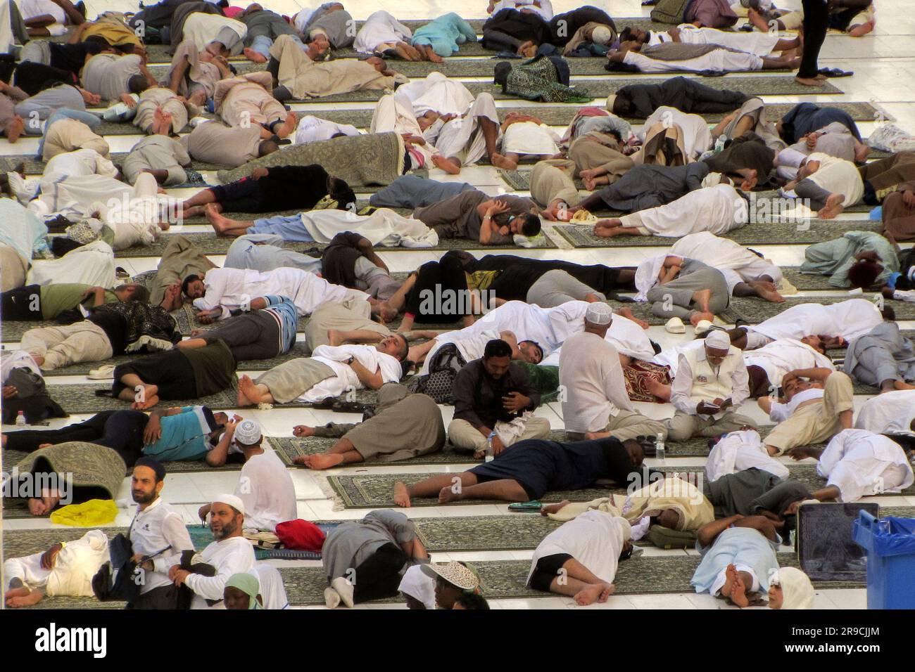 Muslim pilgrims take a nap after dawn prayers outside the Grand Mosque ...