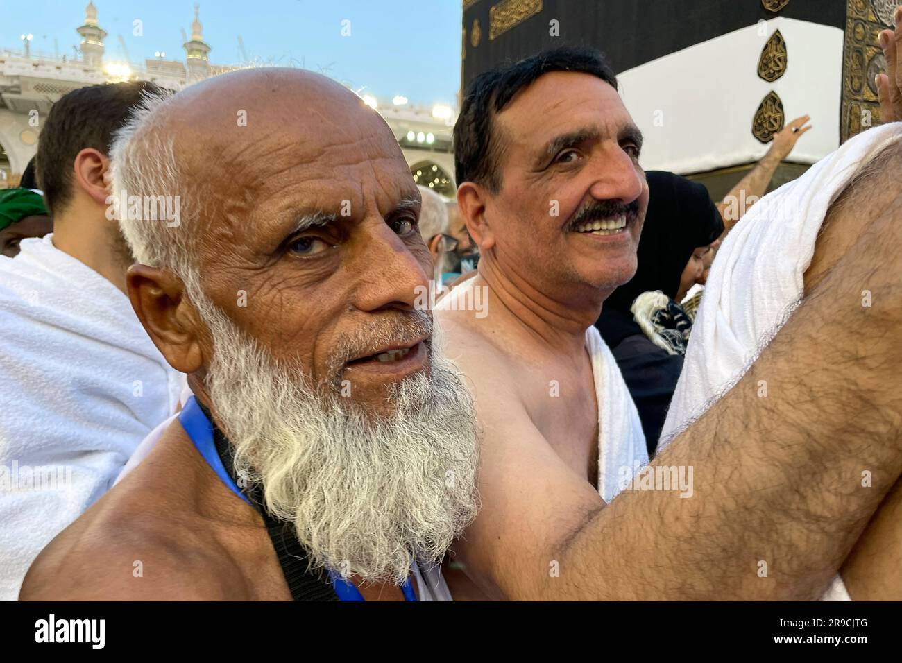 Pakistani pilgrims circumambulate around the Kaaba, the cubic building ...