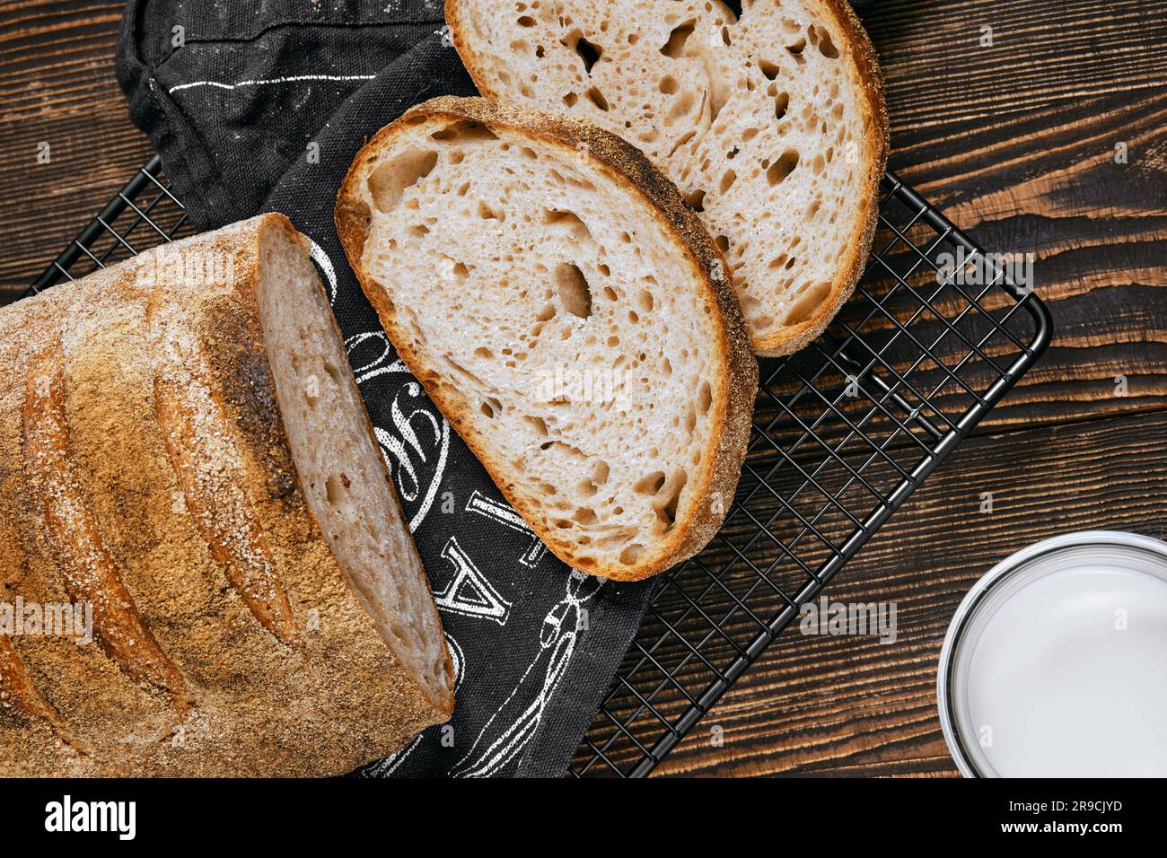 Closeup view of loaf of artisan sourdough bread with porous texture on ...