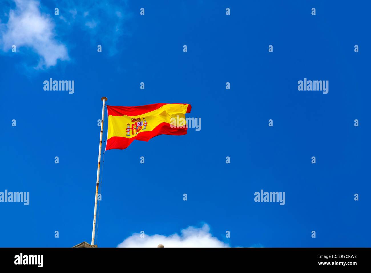 Spanish flag waving in the clear blue sky Stock Photo - Alamy
